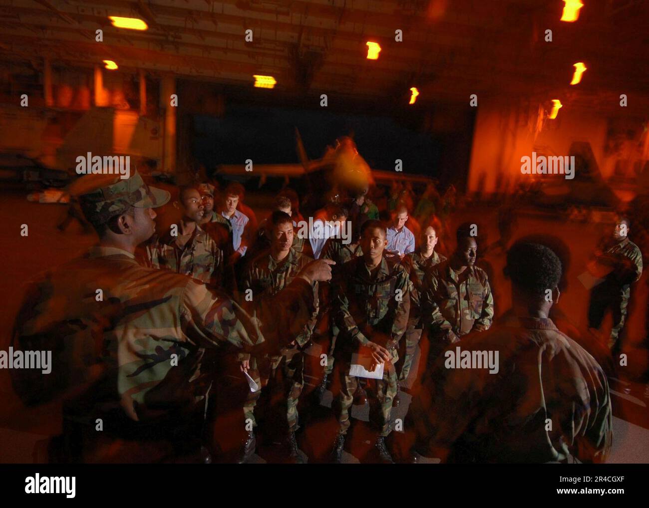 US Navy Security patrols muster in the hangar bay aboard USS Kitty Hawk ...