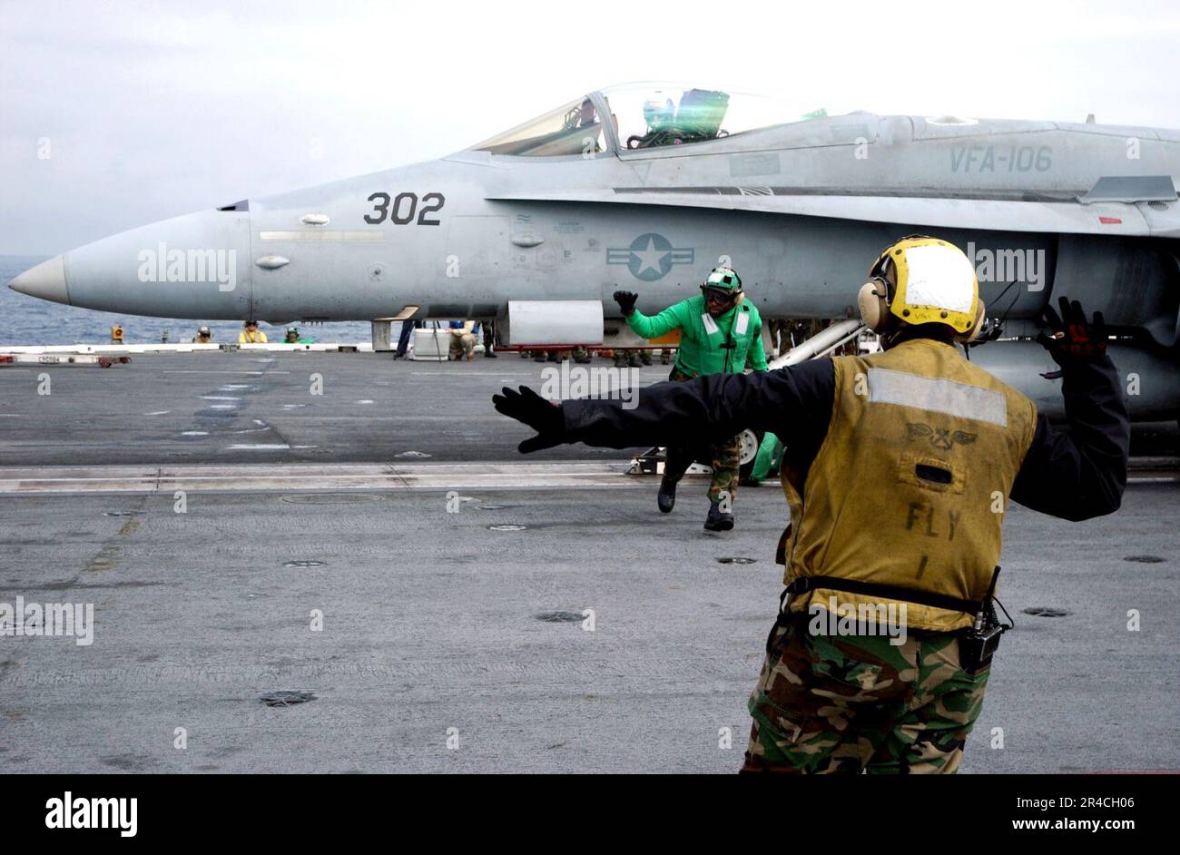 US Navy An Aviation Boatswain's Mate signals to advance the shuttle for ...