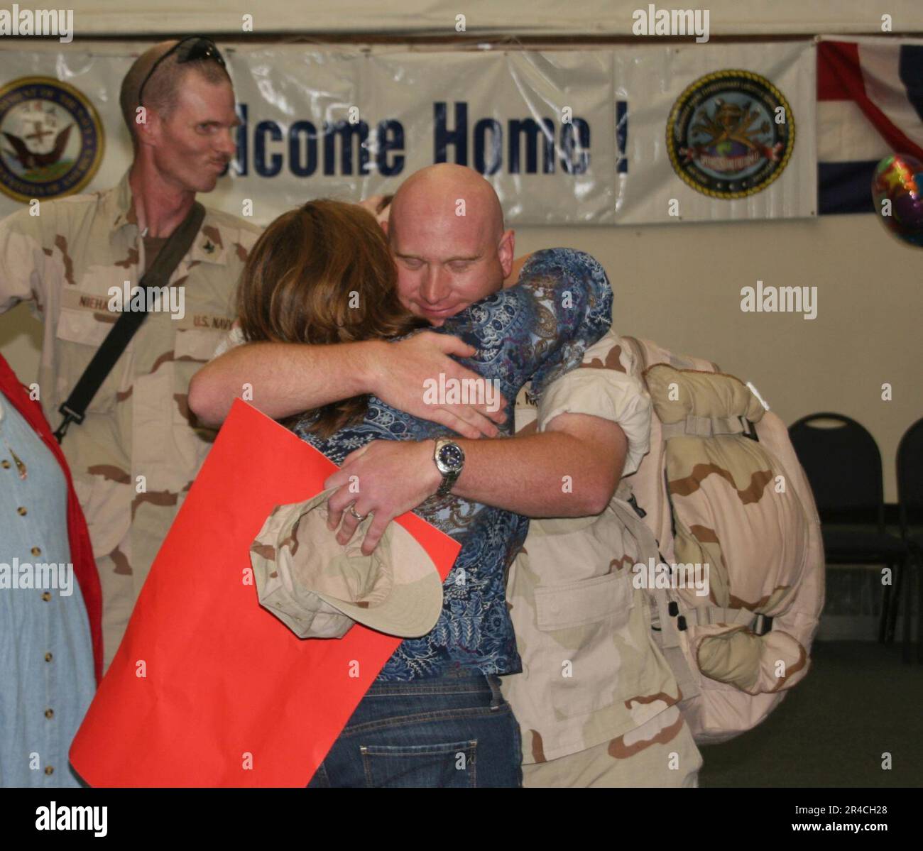 US Navy Storekeeper 3rd Class hugs his wife after a six-month ...