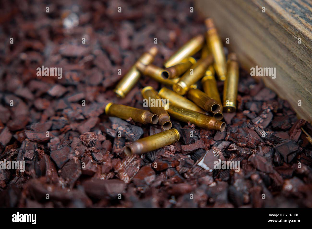 Empty 5.56mm ammunition casings pile up along the edge of a rubber ...