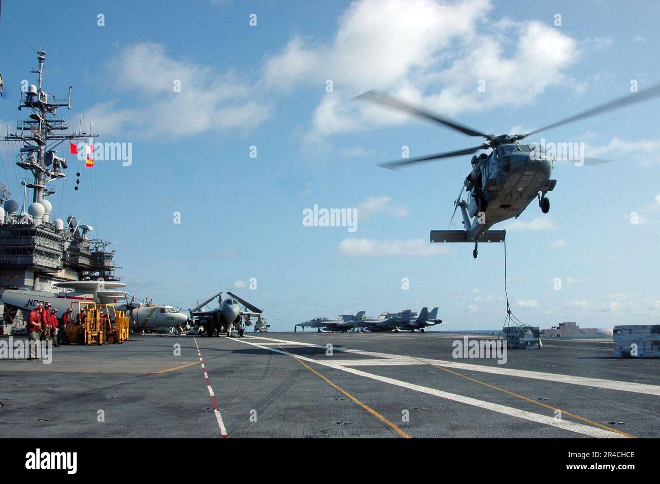 US Navy An MH-60S Seahawk sets munitions on the flight deck aboard USS ...