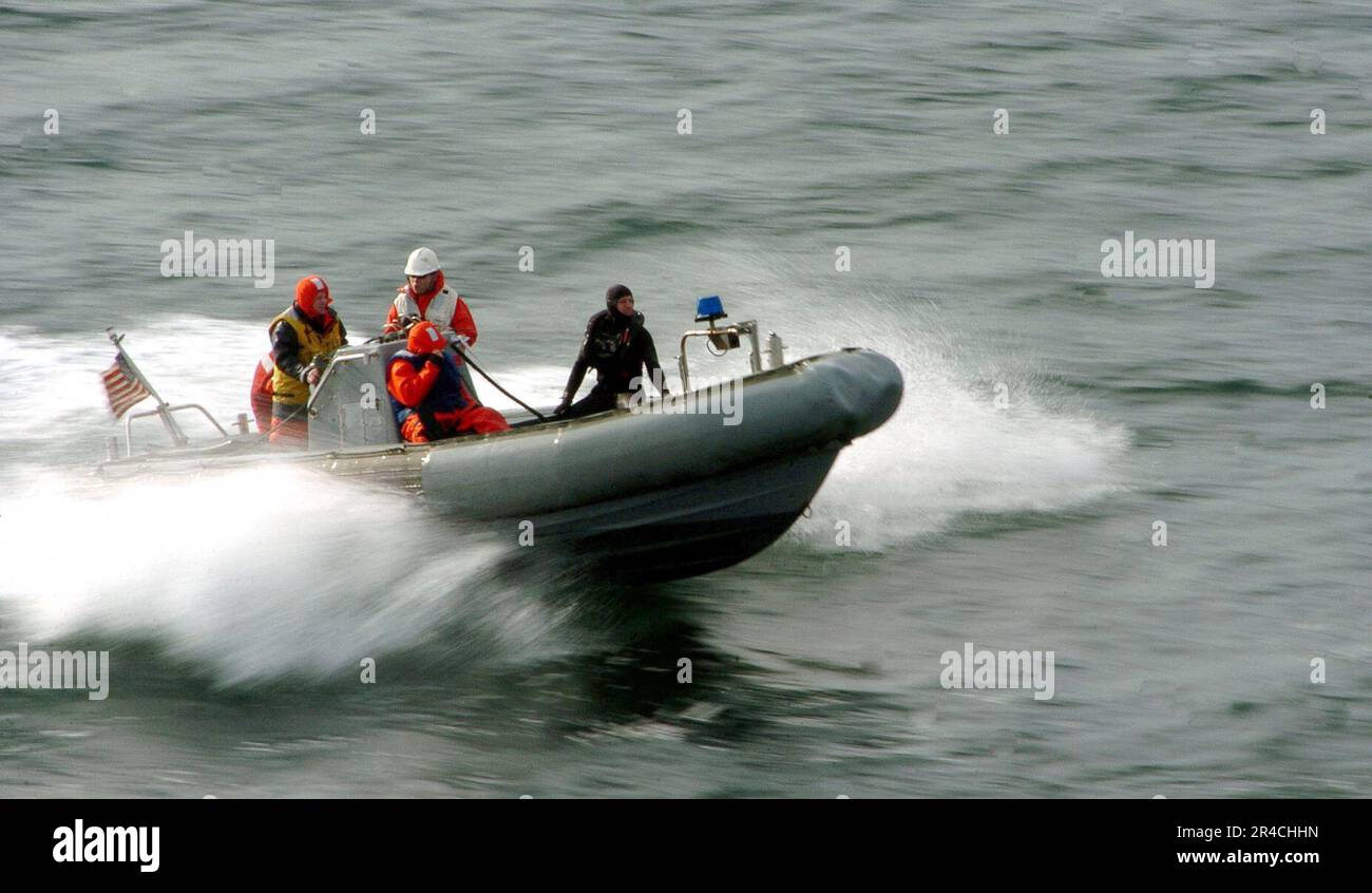 US Navy Boatswain's Mate 2nd Class drives a Rigid Hull Inflatable Boat ...