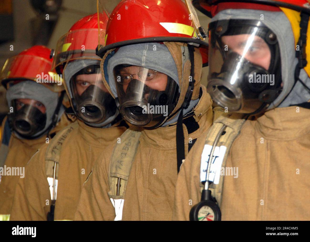 US Navy Sailors dress out in full firefighting equipment while ...