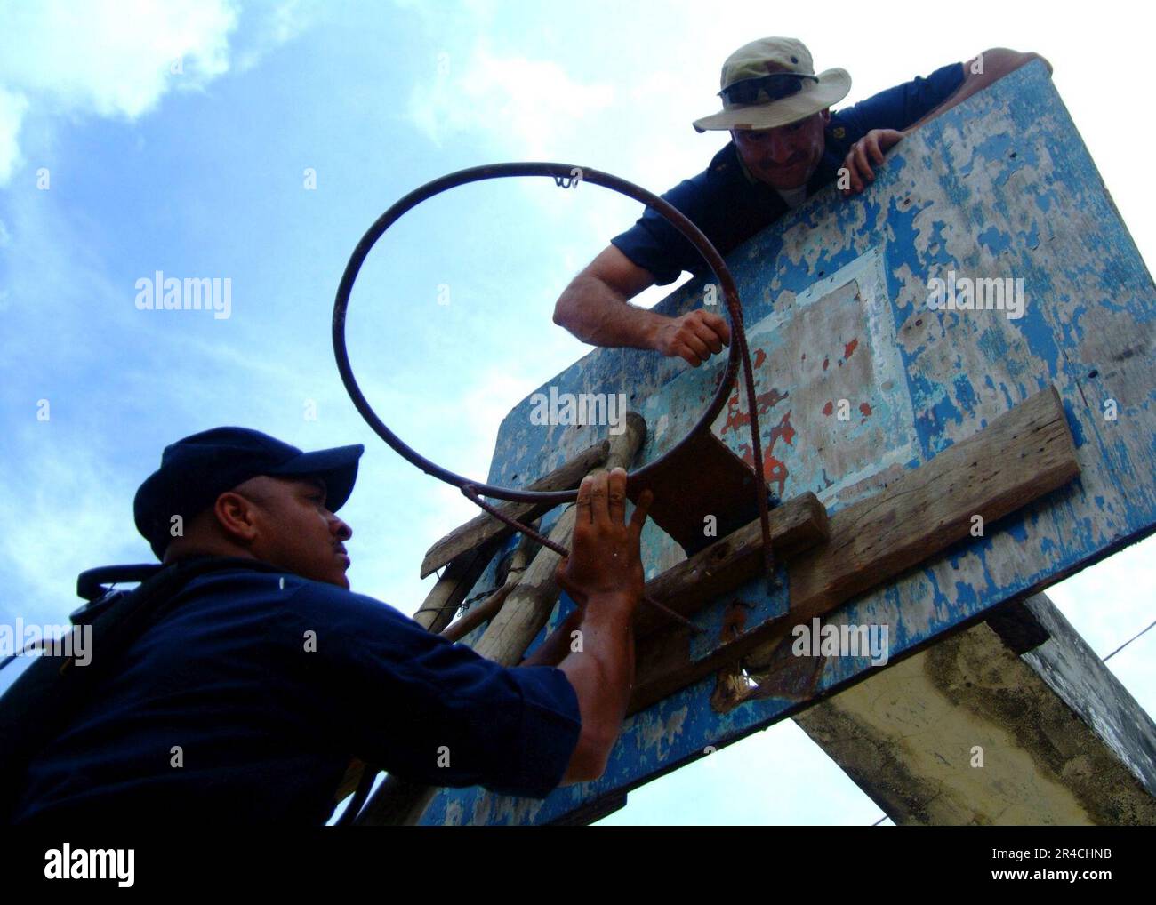 US Navy Boatswain's Mate 2nd Class and Chief Warrant Officer fix a ...