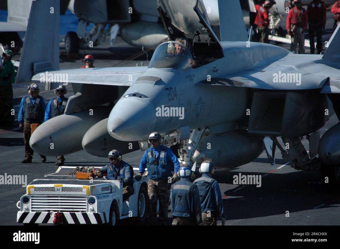 US Navy Flight deck Sailors tow an F-A-18E Super Hornet across the ...
