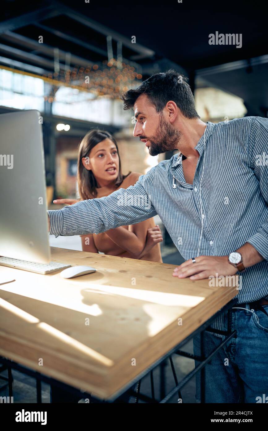 Young colleagues talking about business in the office. Man manager ...