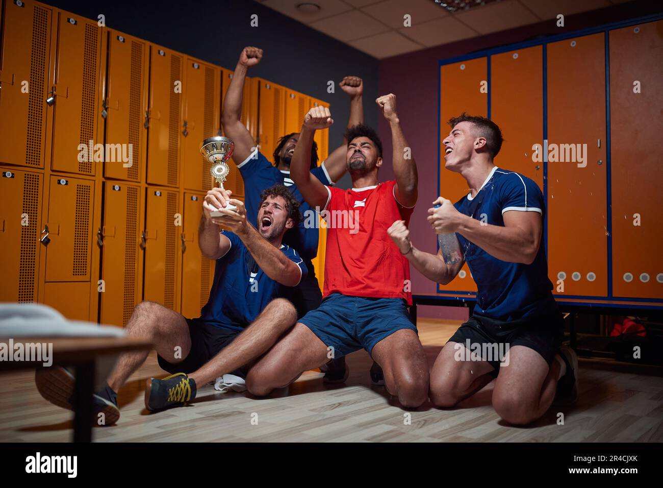 Team of young men football players celebrating success together in the ...
