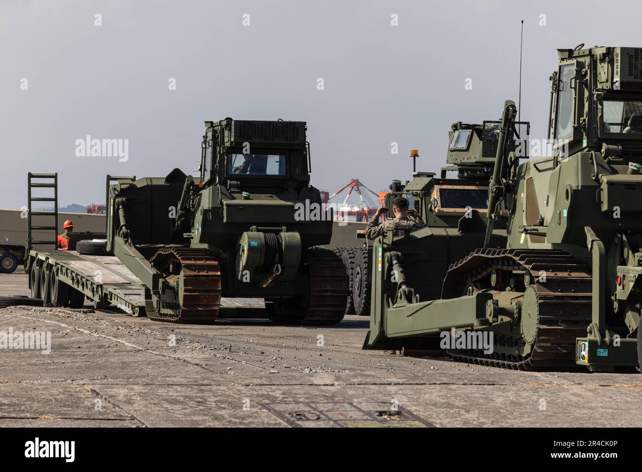 A U.S. Marine with 3rd Landing Support Battalion ground guides an 850JR ...