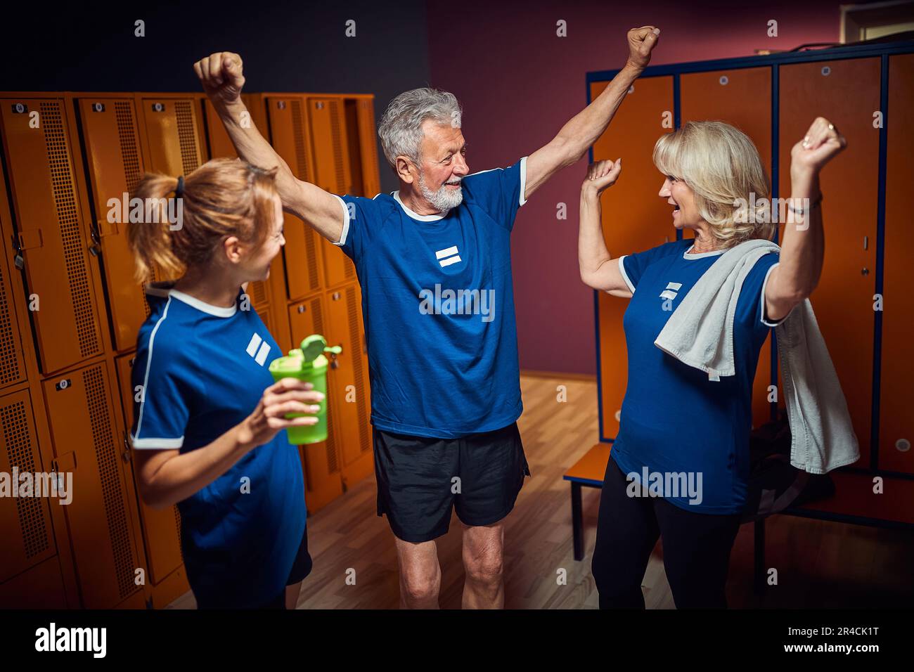 Senior man in sports uniform holding hands up feeling victorious ...