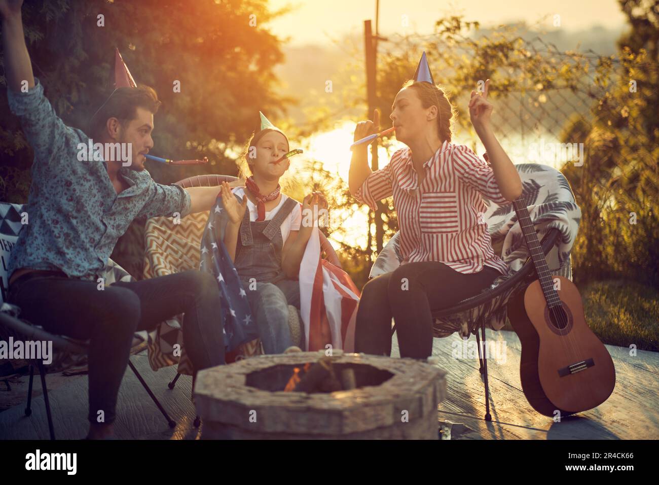 A joyful family celebrating a birthday together. All wearing festive ...