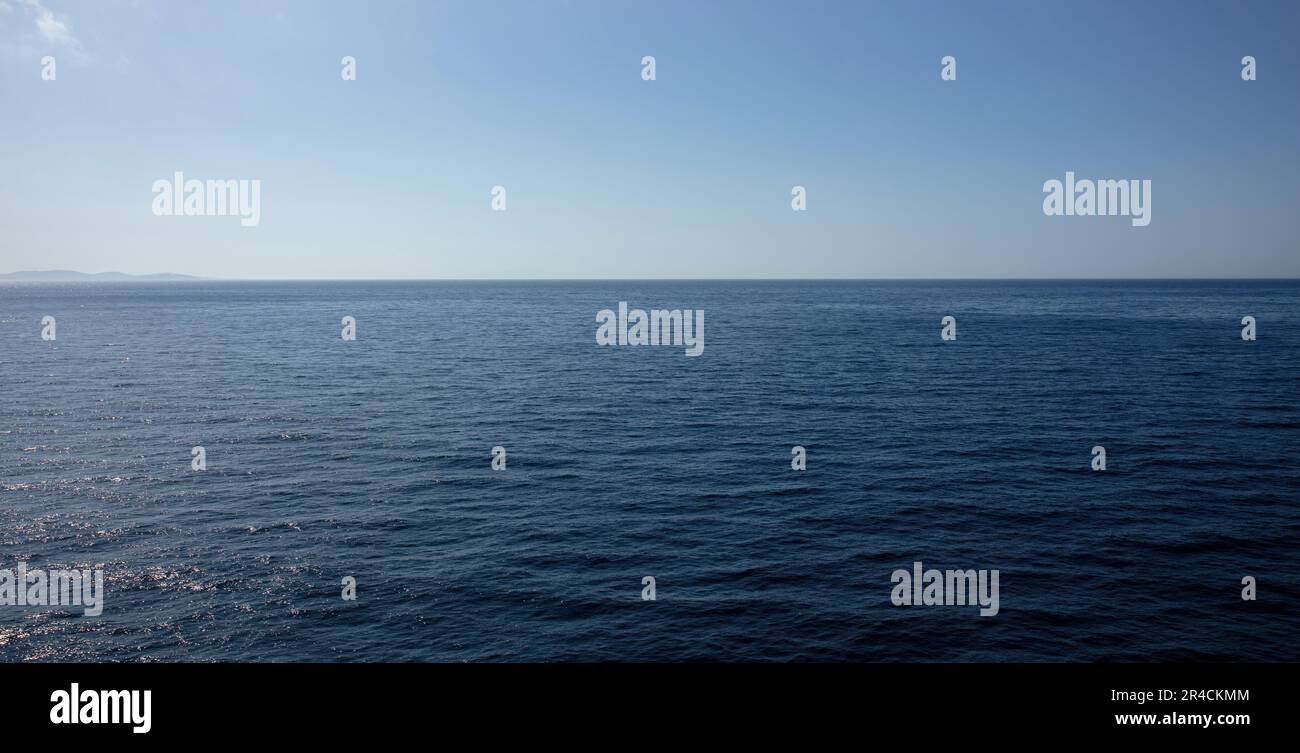 Seascape, calm deep sea water, clear blue sky background texture. Empty ...