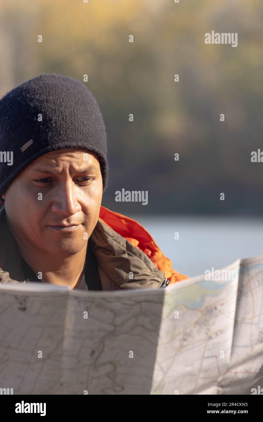 Portrait of traveler man at lake in autumn with a map Stock Photo - Alamy