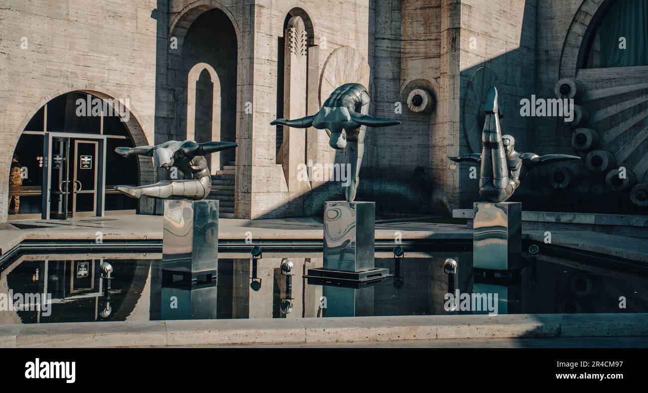 Modern art - stainless steel sculptures of three athletes in the pool ...