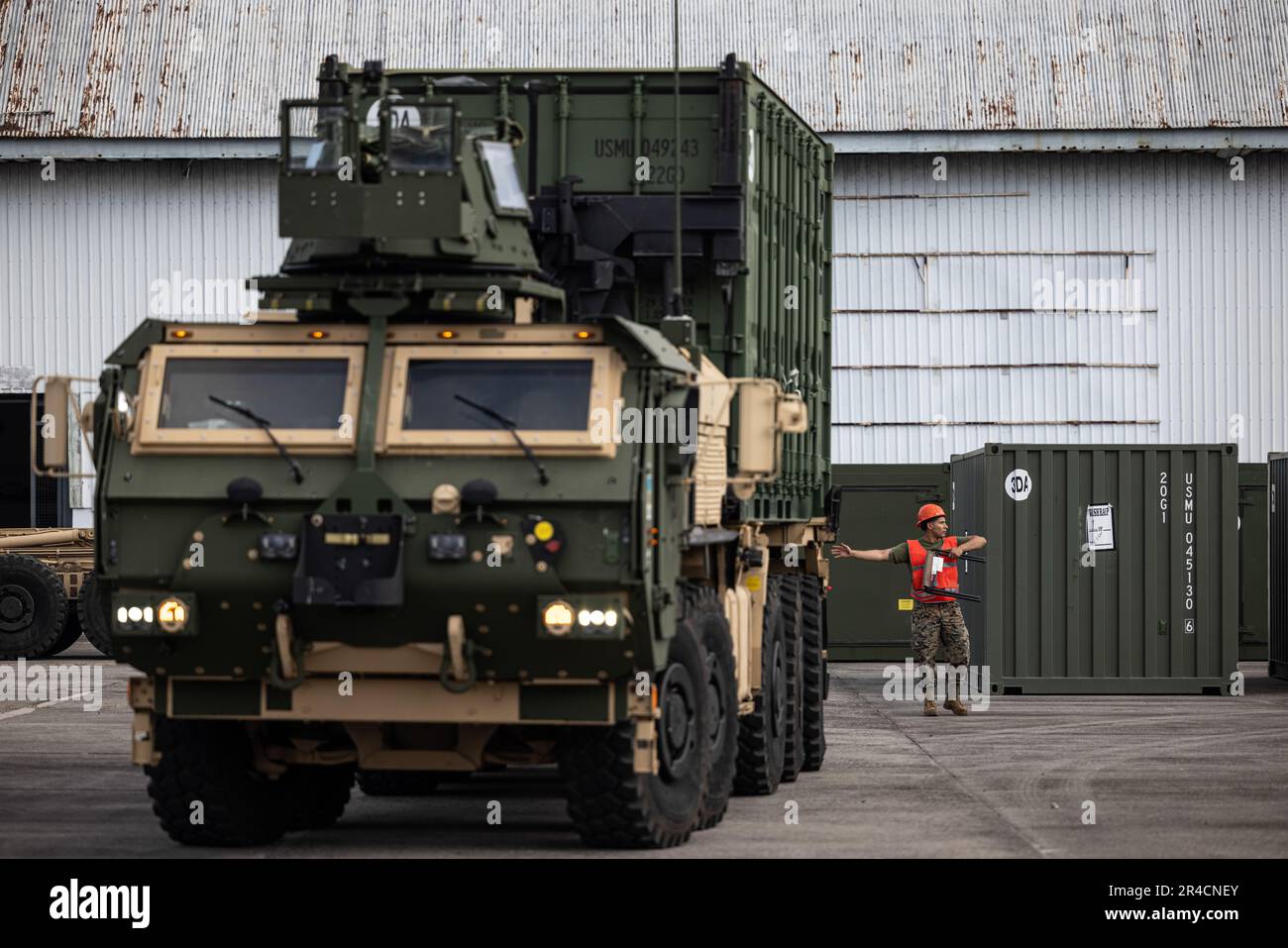 A U.S. Marine with 3rd Landing Support Battalion ground guides a ...