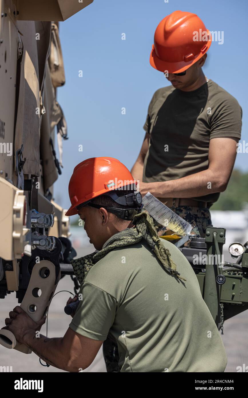 U.S. Marines with 3rd Landing Support Battalion hitch a trailer to a ...