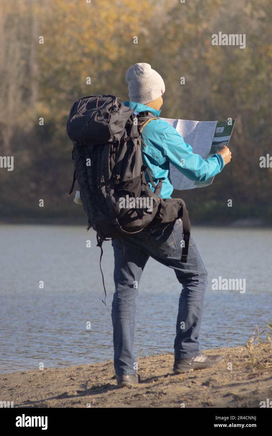 Portrait of traveler man at lake in autumn with a map Stock Photo - Alamy