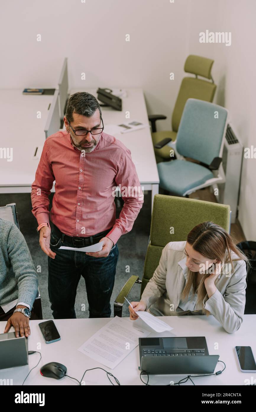 The boss telling his employees about their new job for the client at ...