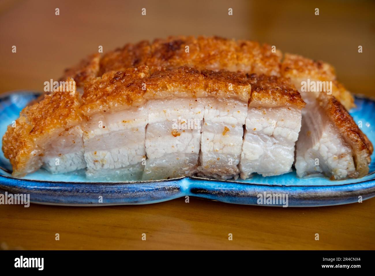 Roasted crispy pork served on a plate, ready to eat Stock Photo - Alamy
