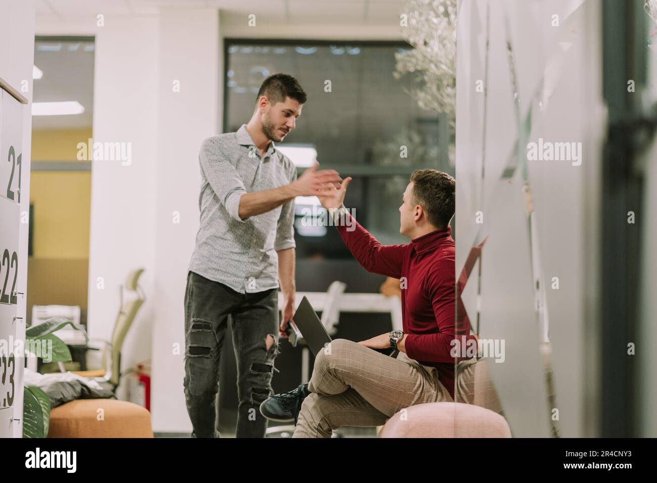 A male business person is tired and leaving the office. He is shaking ...