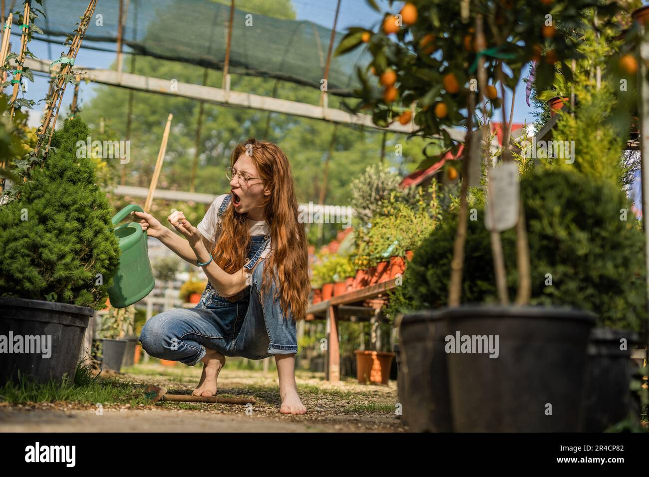 Garden girl reaction after she hurt her finger while watering flowers ...
