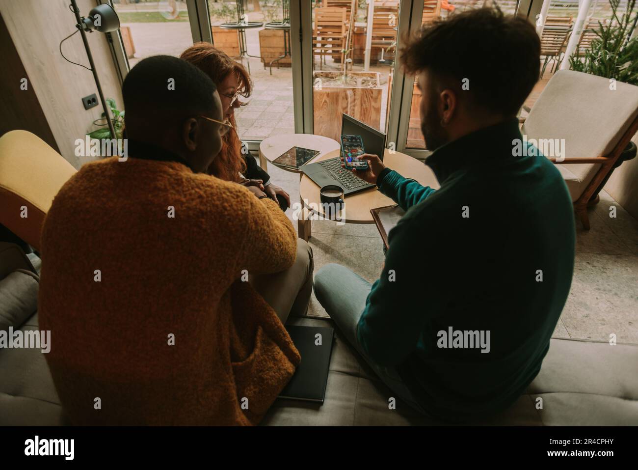 Multiracial people taking a break from work. Male person showing ...