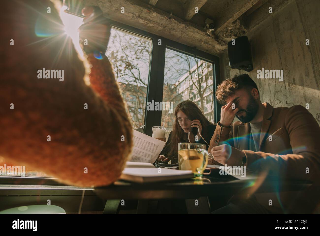 Tired business people at the end of the working shift. Ginger woman ...