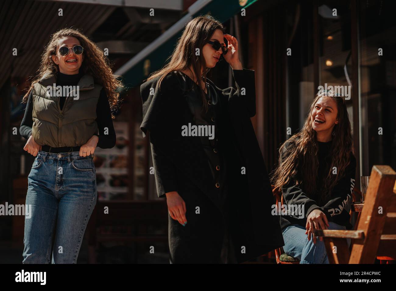 Two smiley girls listening to their female telling a fun story. They ...
