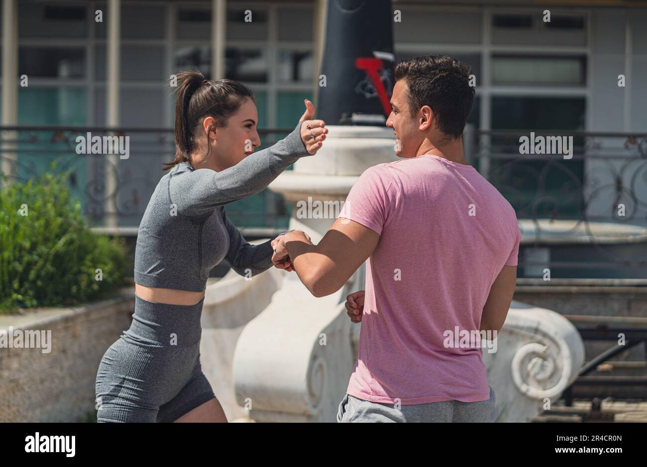 Cute girl slapping her male friend while he is joking with her Stock ...