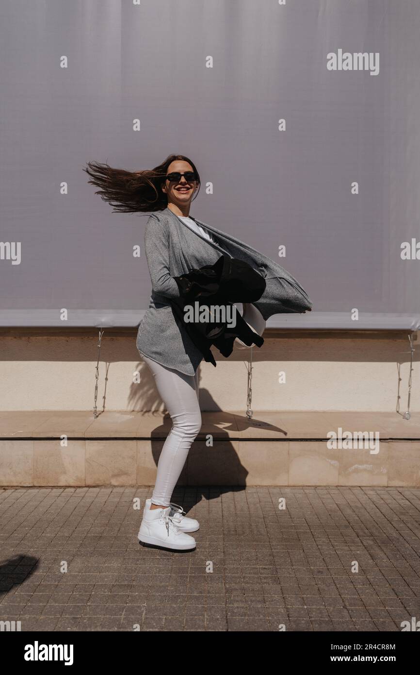 Beautiful brunette girl spinning around and smiling in front of the ...