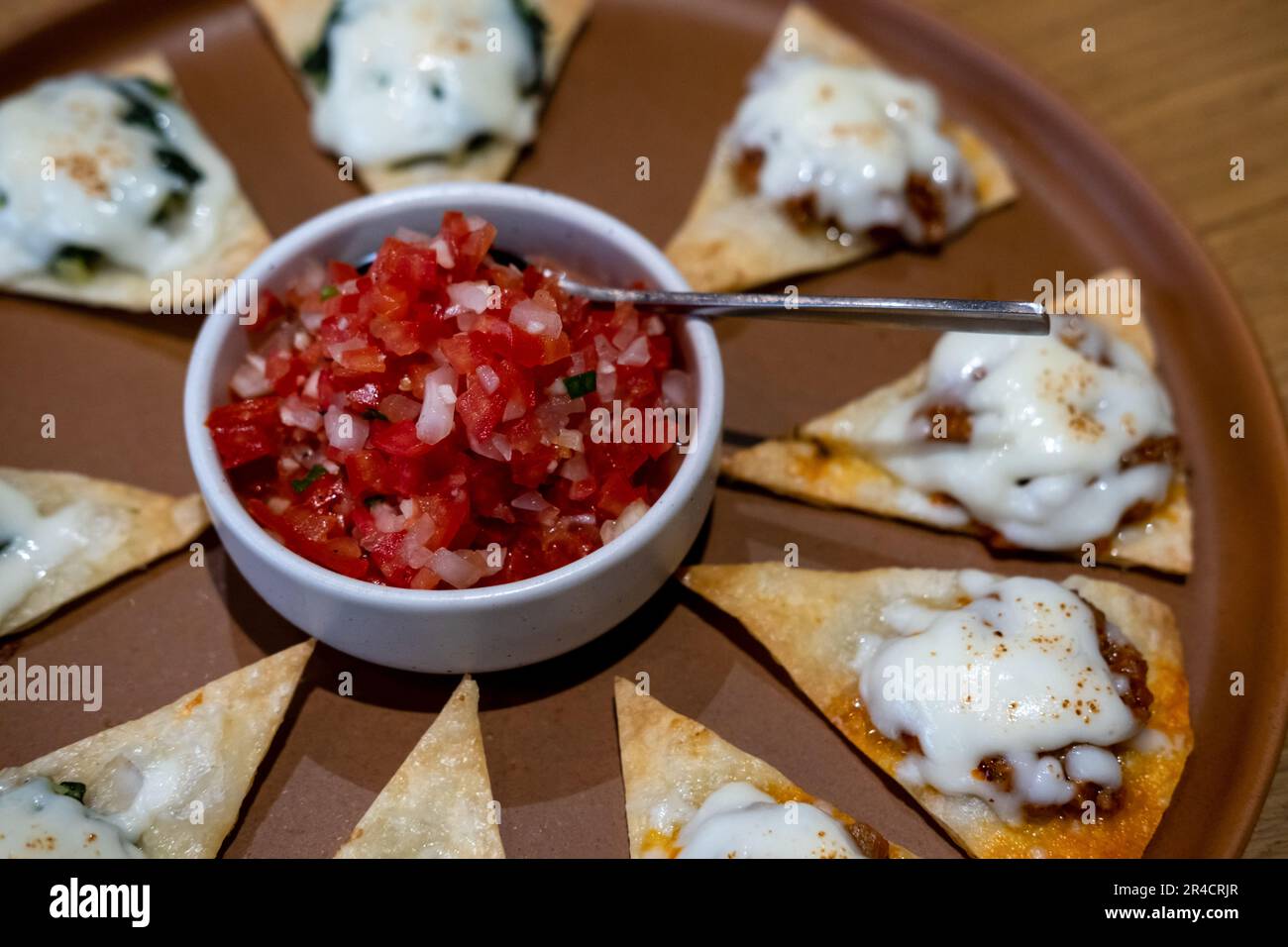 Cheese Nacho with spinach and meat, served with tomato salsa dip sauce ...