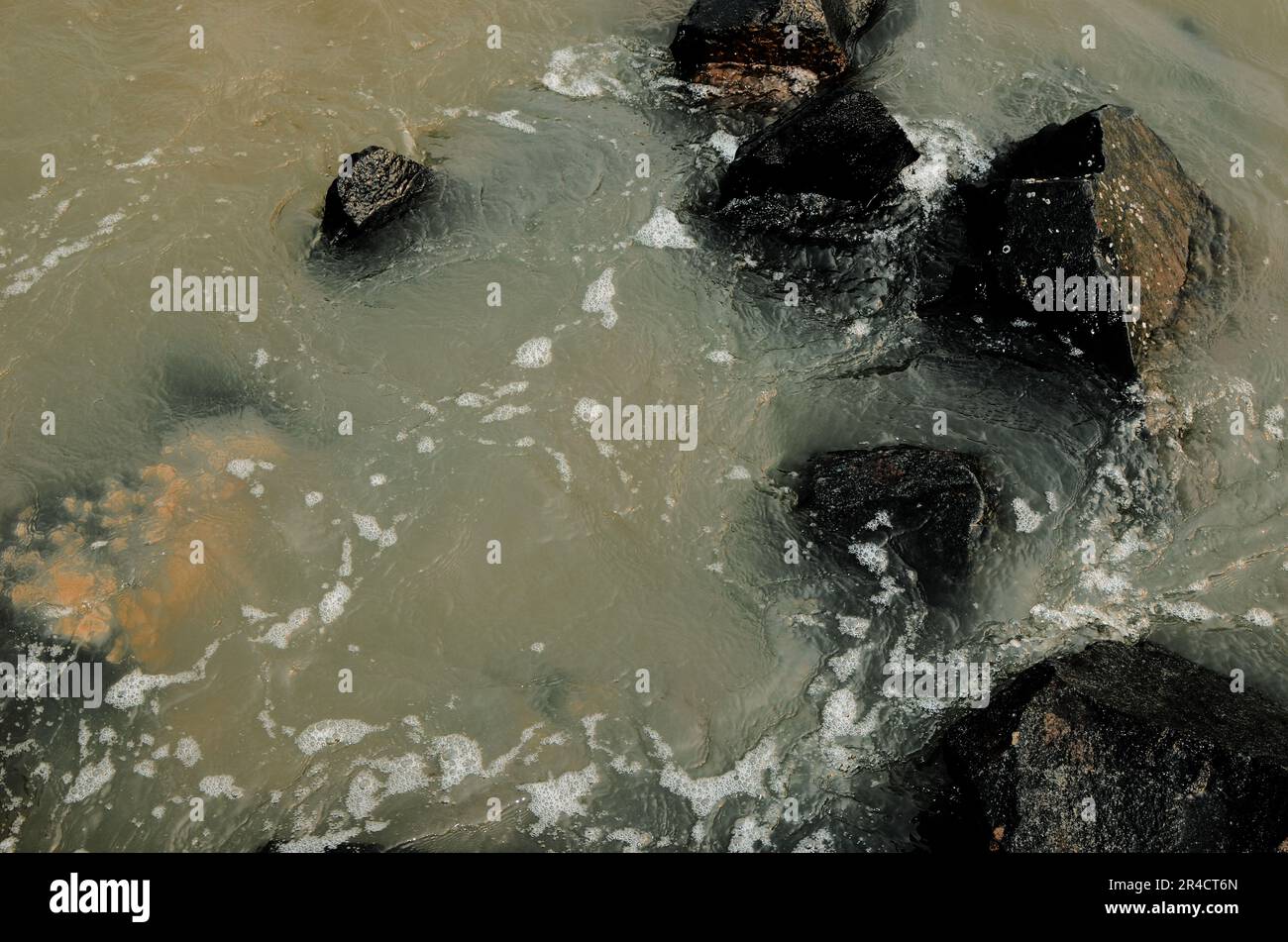 Rock submerged in sea water Stock Photo - Alamy