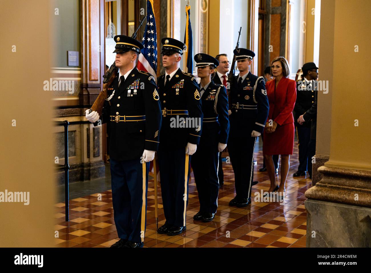 An Iowa National Guard color guard team stands at attention before ...