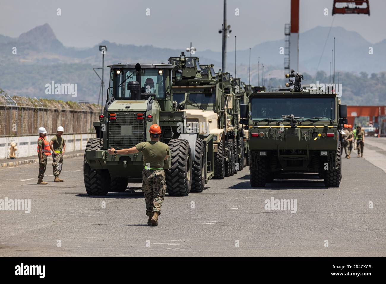U.S. Marines with 3rd Landing Support Battalion guide vehicles to the ...