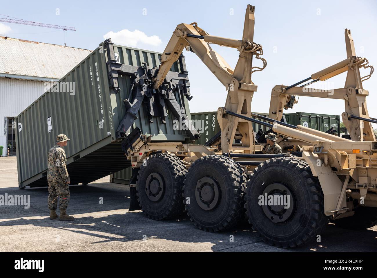A U.S. Marine with 3rd Landing Support Battalion supervises a shipping ...