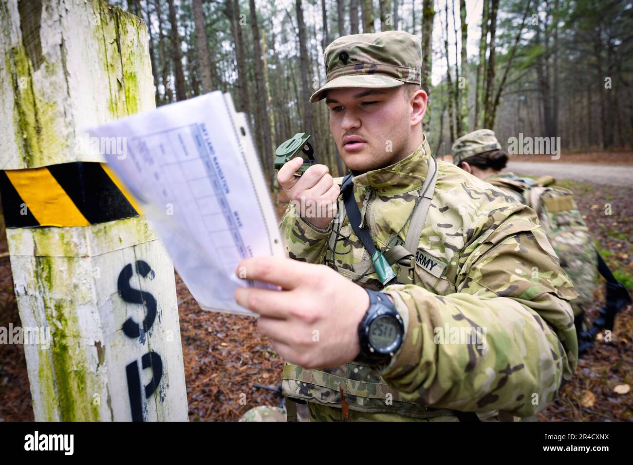 A Soldier takes a last look at his calculations before setting out to ...