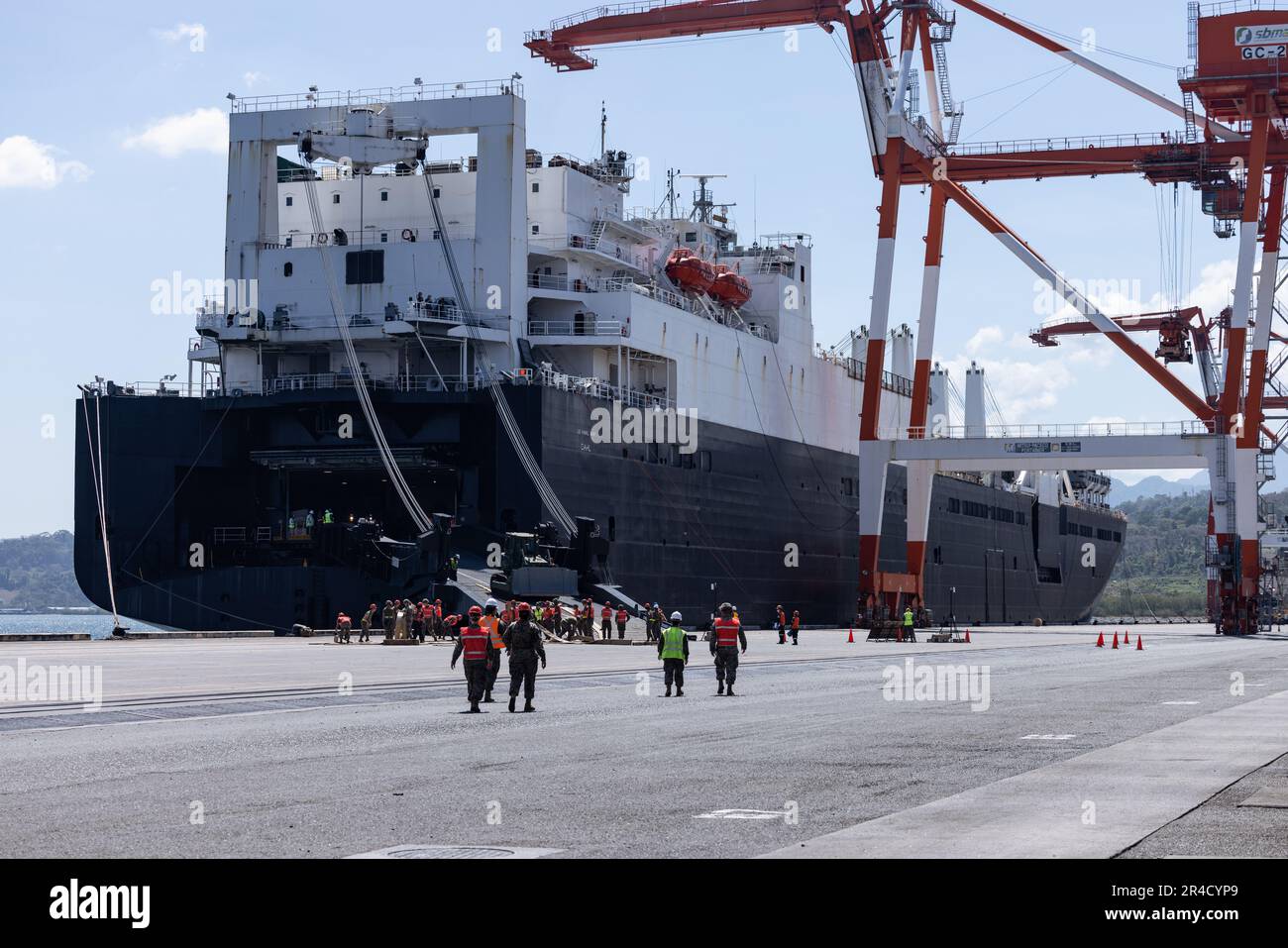 U.S. Marines and Filipino civilians offload equipment from U.S. Naval ...