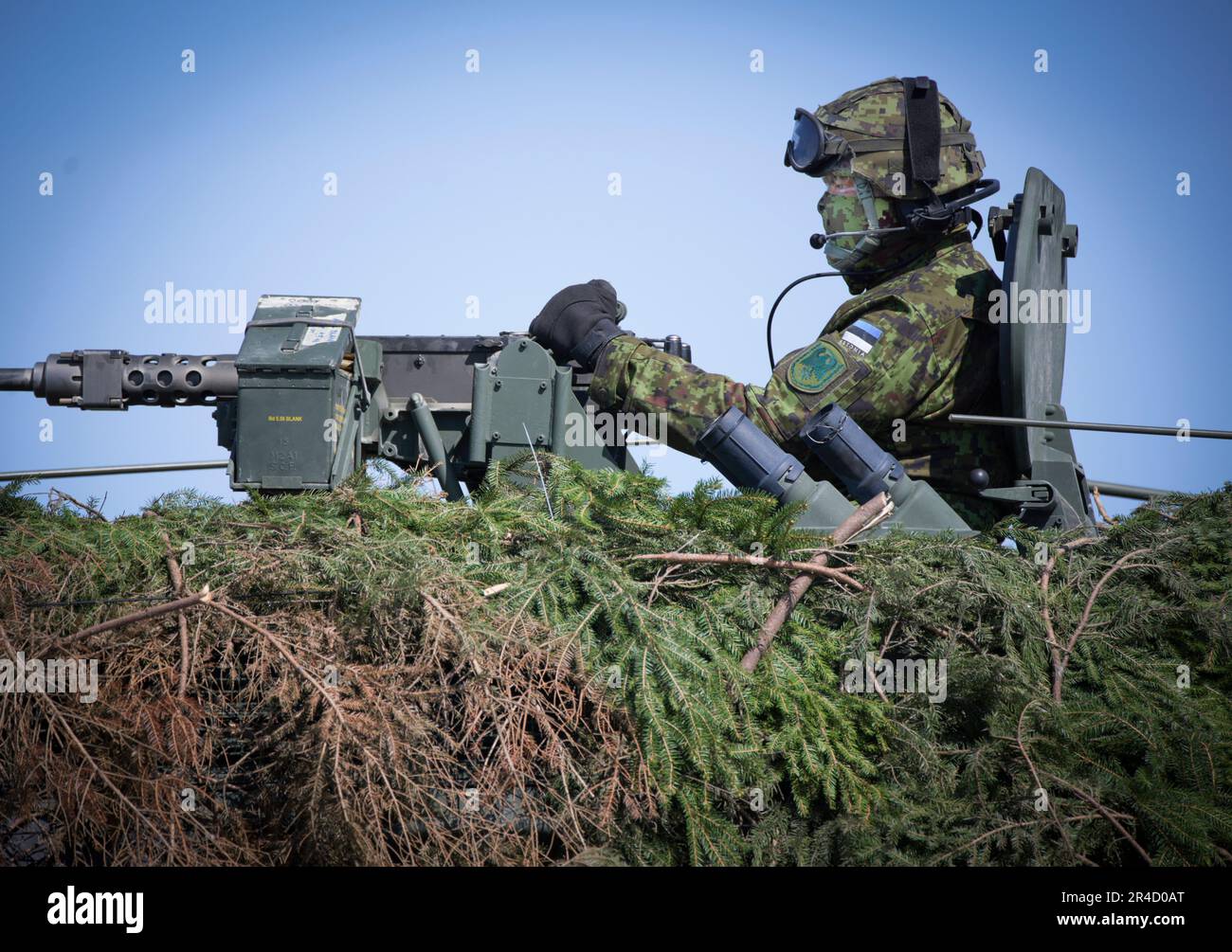 An Estonian soldier is seen in a camouflaged armoured personnel carrier ...
