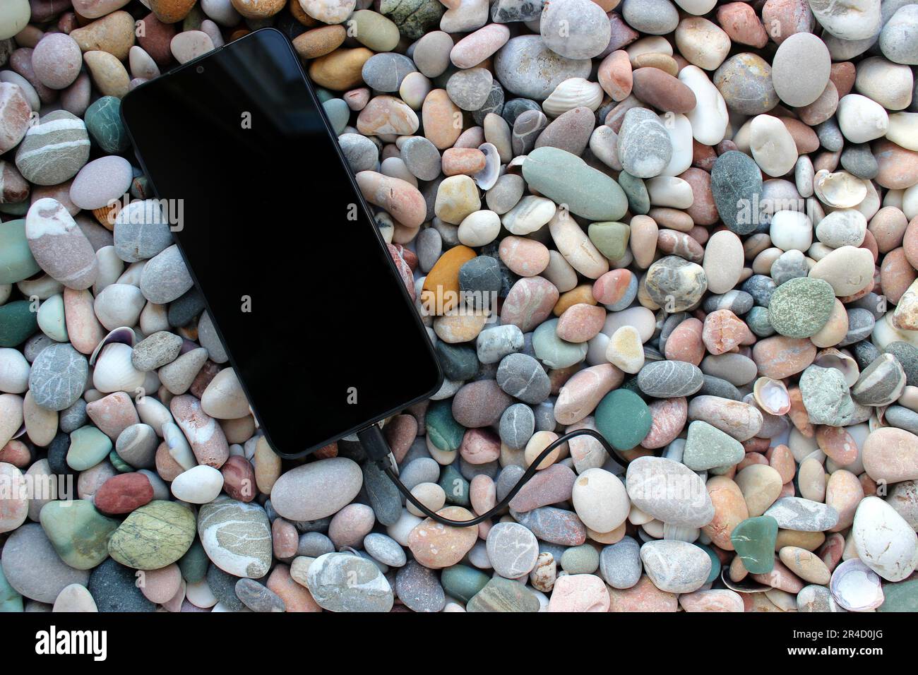 Black smartphone being charged from hi-res stock photography and images ...