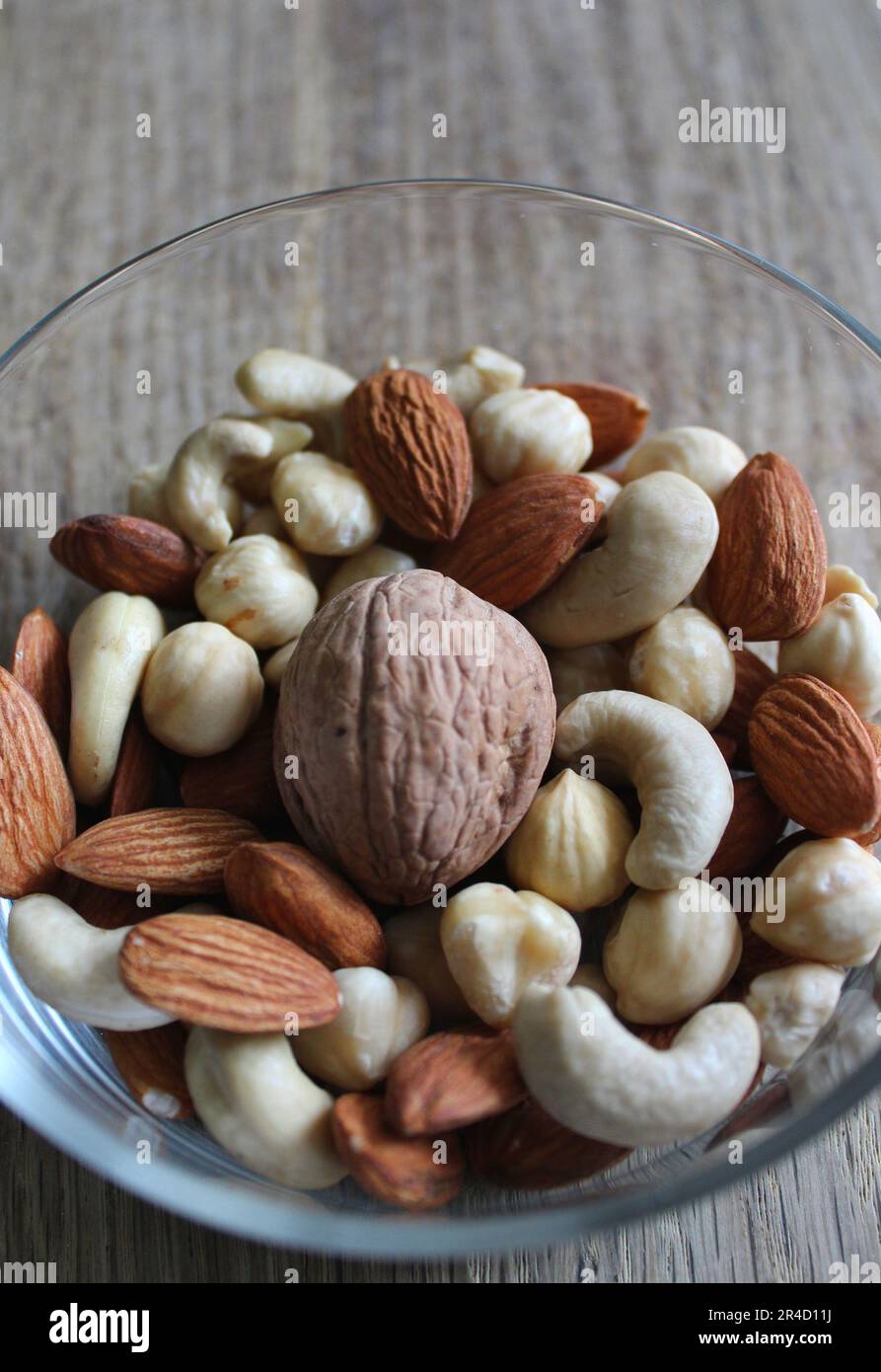 Vertical Stock Photo Of Glass Plate With Heap Of Whole And Shelled Nuts ...