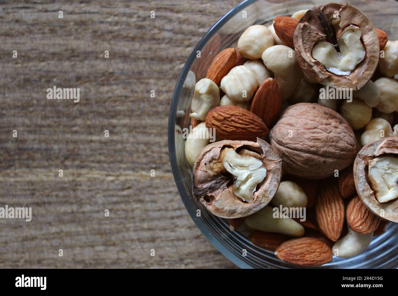 Walnut halves and whole kernels of different varieties of nuts on a ...