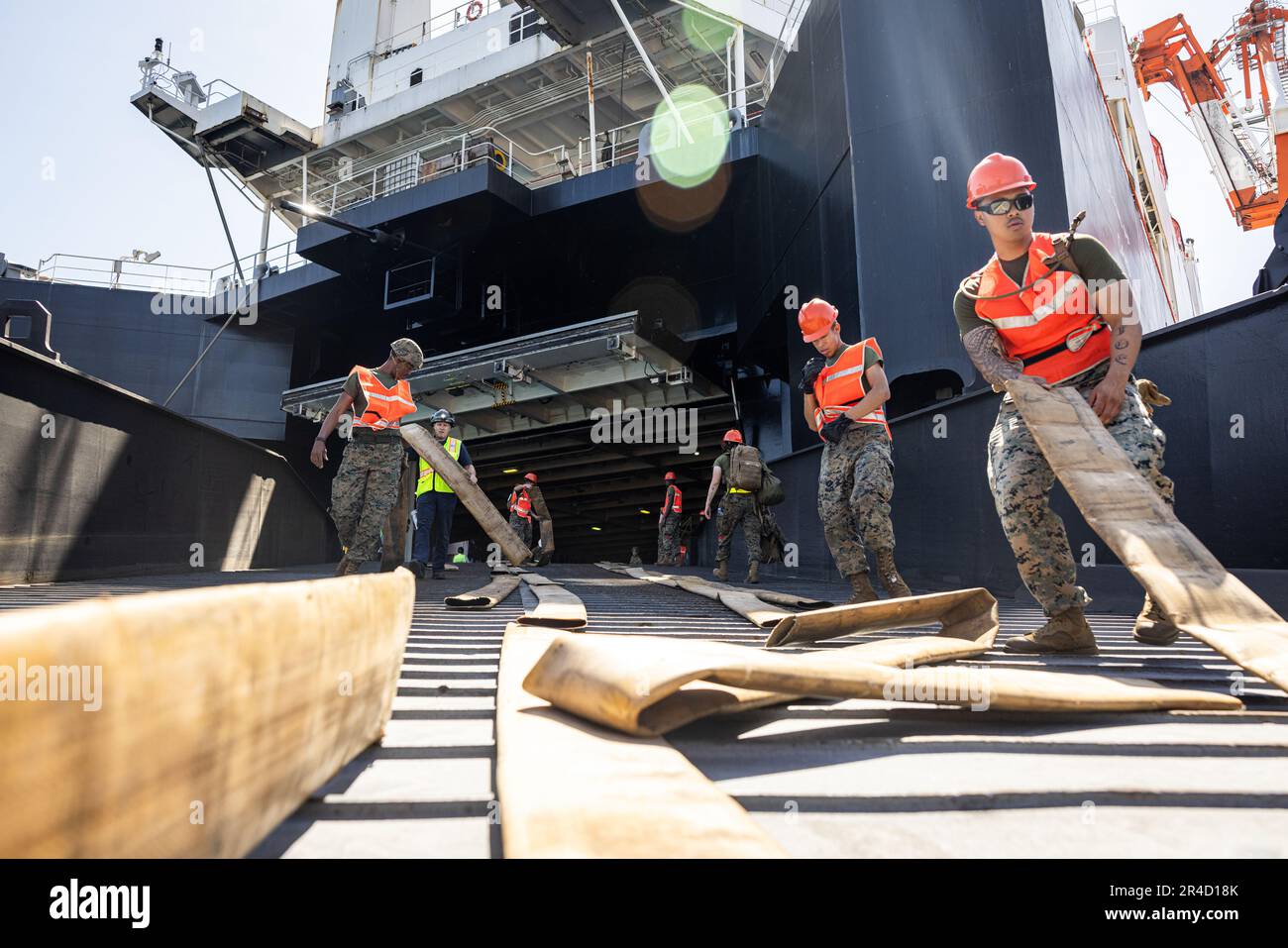 U.S. Marines with 3rd Landing Support Battalion lay down fire hoses ...