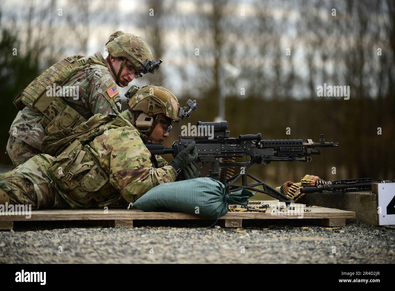 U.S. Army Spc. William Mullins acts as assistant gunner for Spc ...