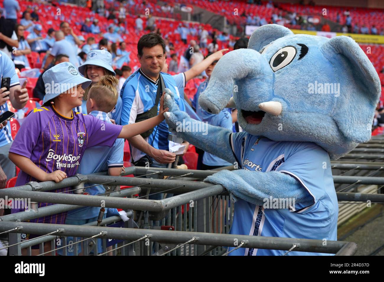 A young Coventry City fan with team mascot Sky Blue Sam in the stands ...