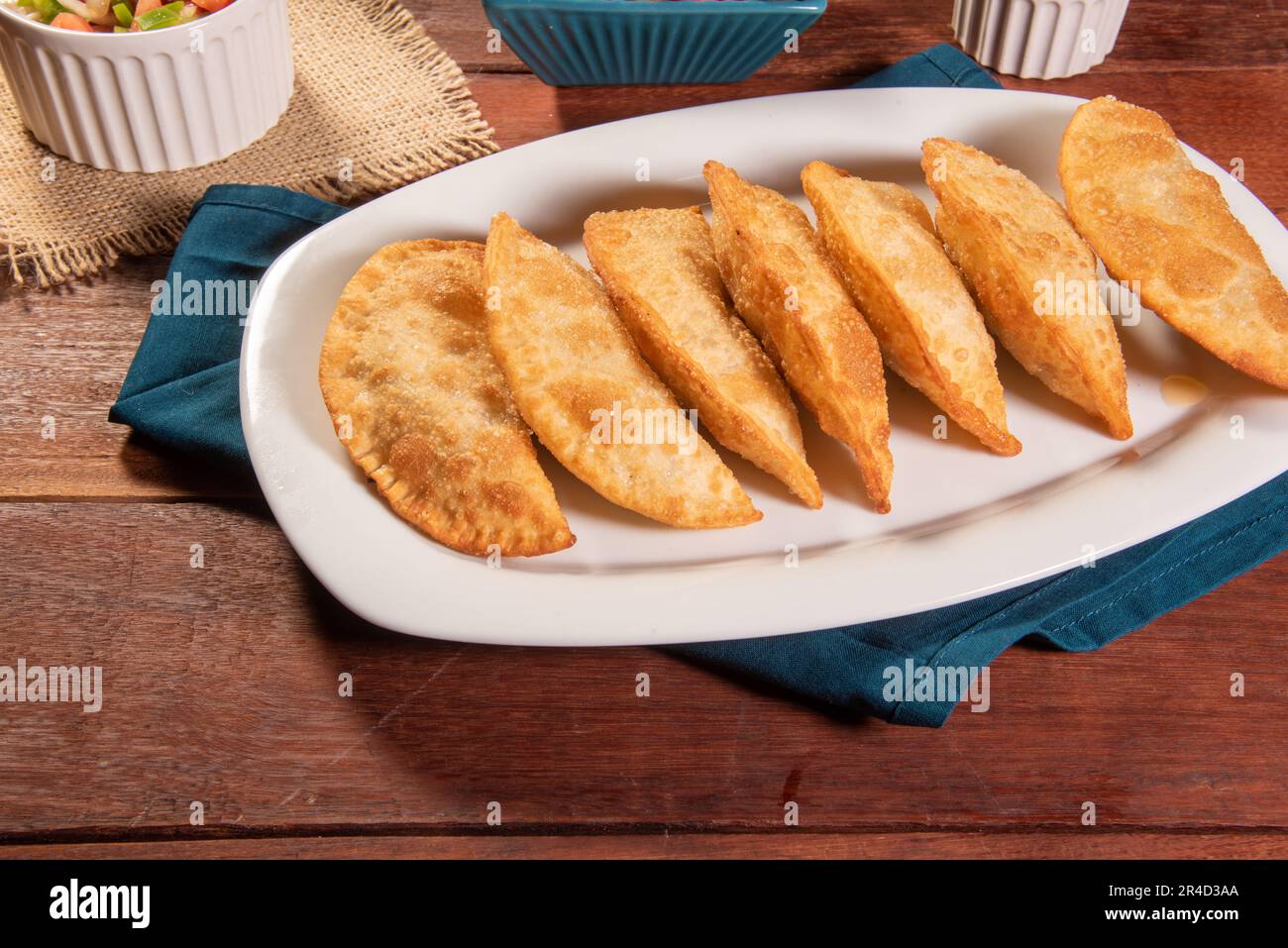 Fried Pastries, Pastel Frito Brasileiro, on wooden table. Pastel de ...