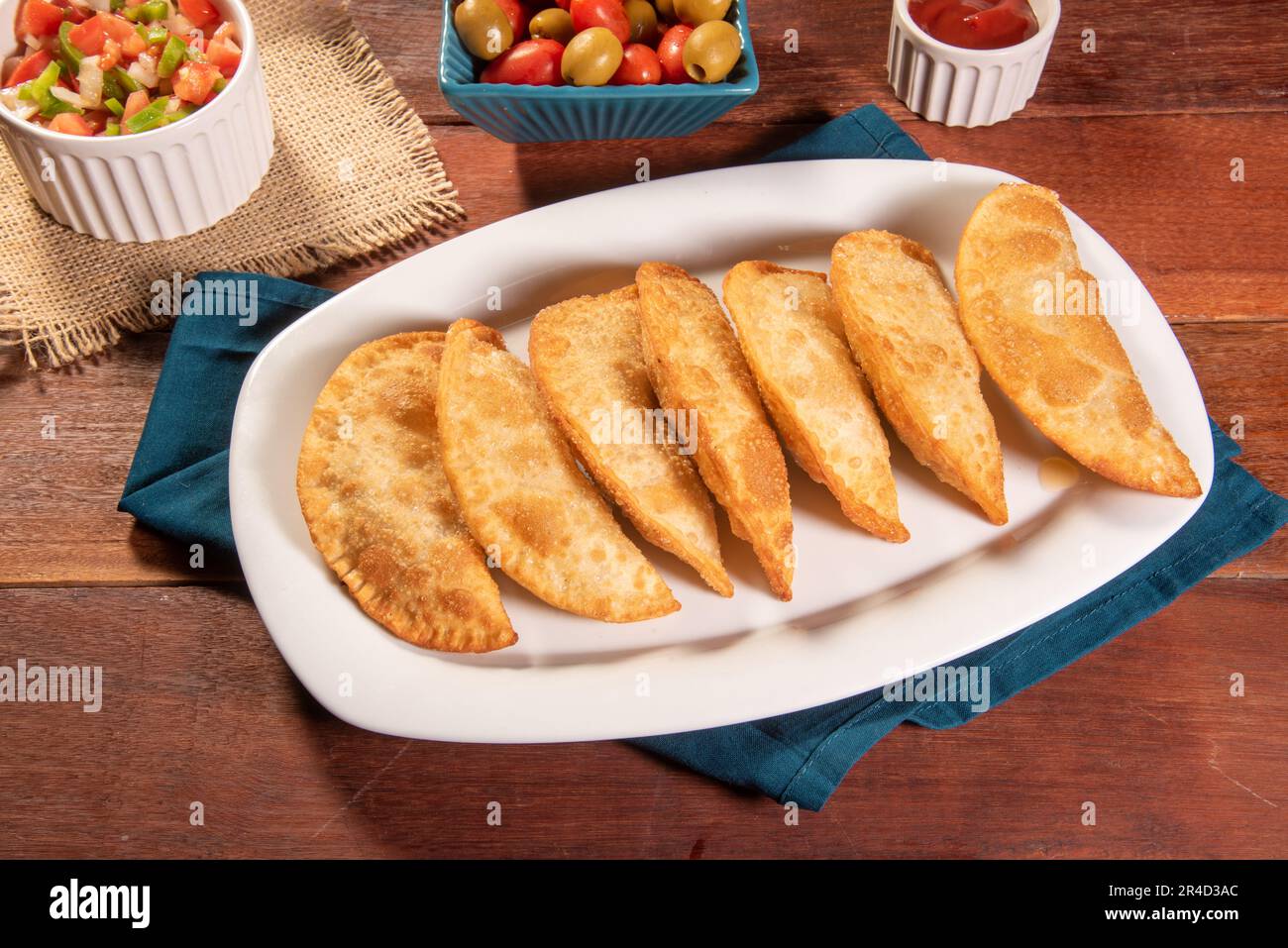 Fried Pastries, Pastel Frito Brasileiro, on wooden table. Pastel de ...