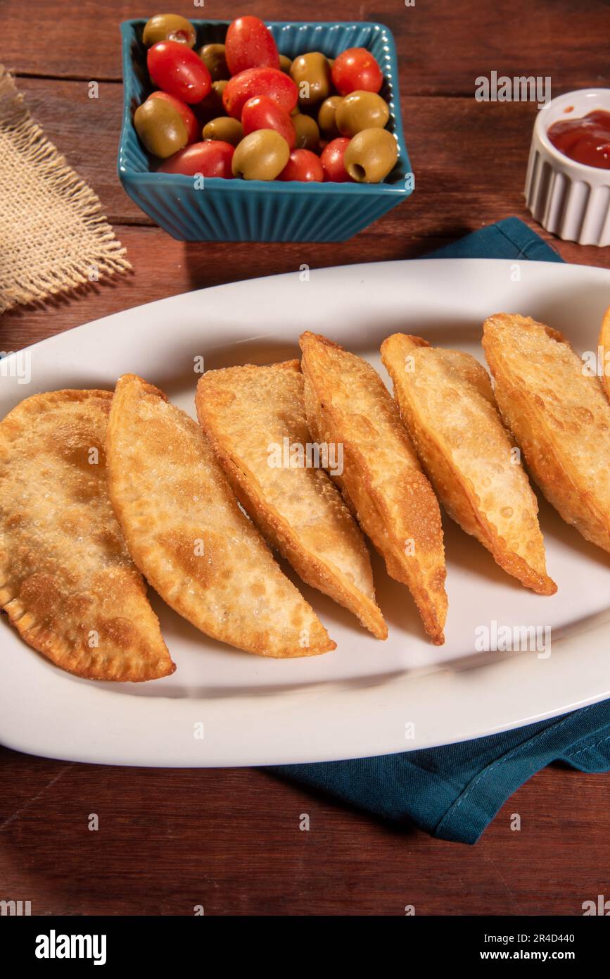 Fried Pastries, Pastel Frito Brasileiro, on wooden table. Pastel de ...