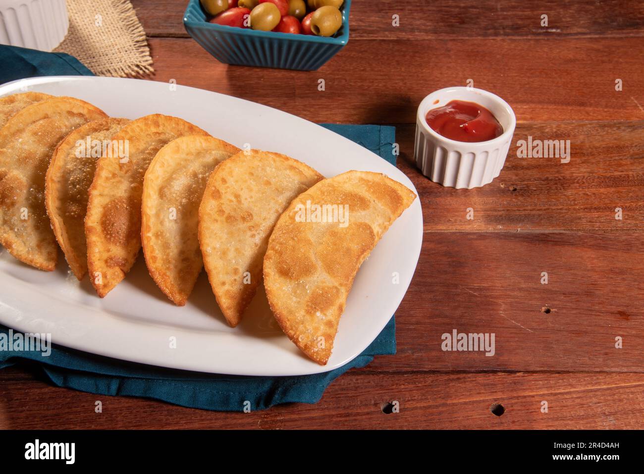 Fried Pastries, Pastel Frito Brasileiro, on wooden table. Pastel de ...