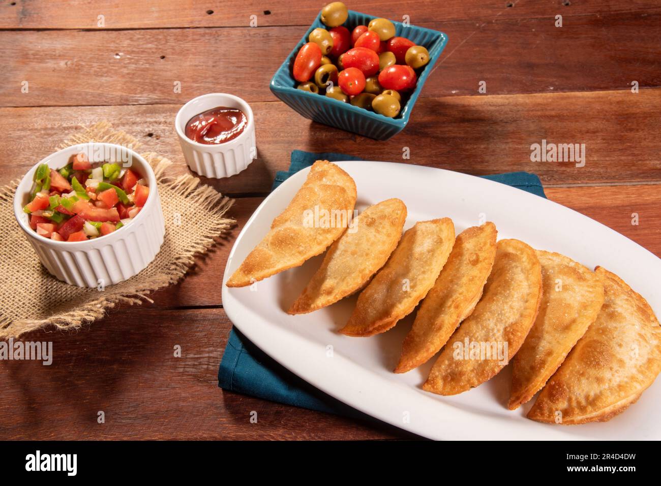 Fried Pastries, Pastel Frito Brasileiro, on wooden table. Pastel de ...