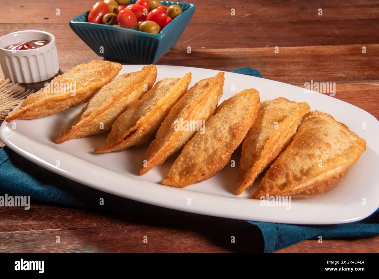Fried Pastries, Pastel Frito Brasileiro, on wooden table. Pastel de ...