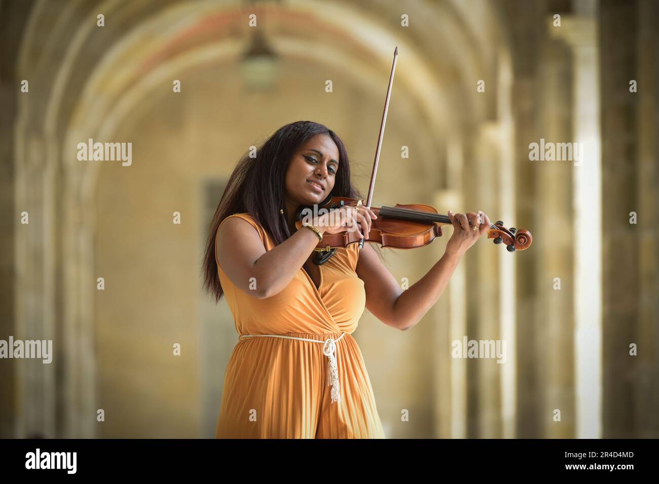 Lovely black woman playing violin in the street in Paris in France ...